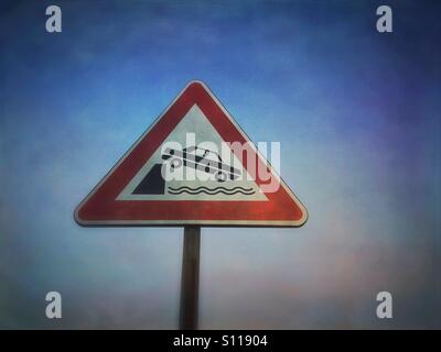 Warning triangle traffic sign of unprotected quayside and danger ...