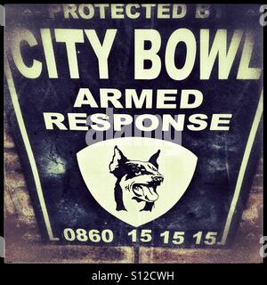 An armed response security sign on the side of a building in the Stock ...