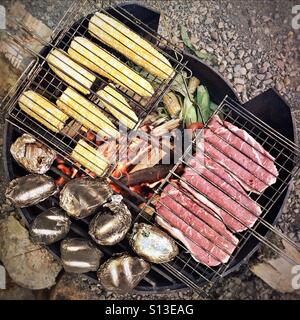 Cooking potatoes over an open fire in a guest house in the Manaslu ...
