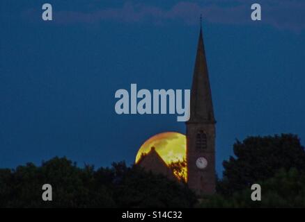 Harvest Moon rising behind Chryston Parish Church, Scotland Stock Photo ...
