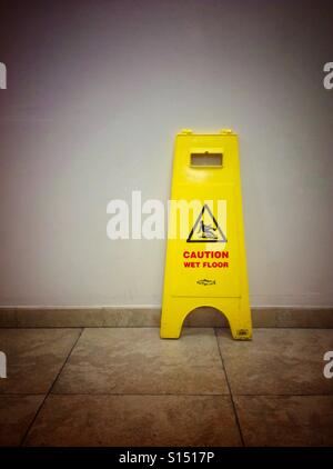 Yellow Wet Floor Sign Stock Photo - Alamy