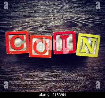 Word coins written with wooden letters on rustic surface Stock Photo ...