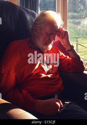 Old man asleep in the afternoon sunshine, Devon, England Stock Photo ...