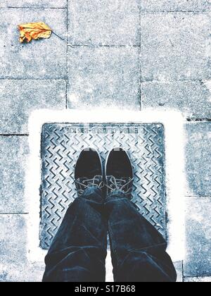 Two feet, one bare & one in shoes, going in opposite directions, close ...