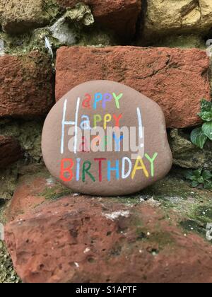 Happy Birthday stone on a rock and moss Stock Photo - Alamy