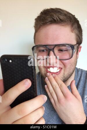 A goofy man wearing nerd glasses isolated over white with a funny ...