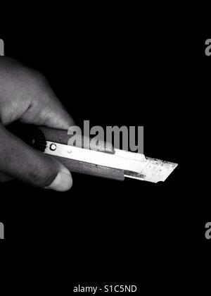 Hand Holding a Cutter Knife, white background Stock Photo - Alamy