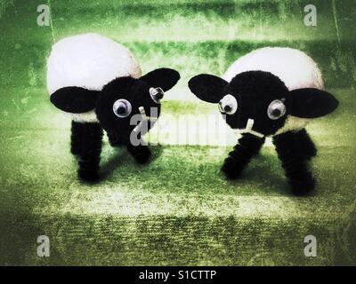 Two sheep with googly eyes on green Stock Photo - Alamy