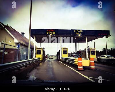 Cars approaching toll booth Stock Photo - Alamy
