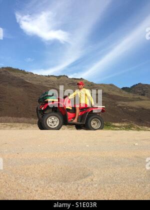 lifeguard patrolling beach on ATV Stock Photo - Alamy