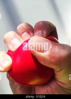 Stress ball being squeezed by Caucasian man, USA Stock Photo - Alamy