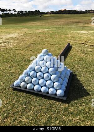 Pyramid of golf balls at a Golf driving practice range Stock Photo - Alamy