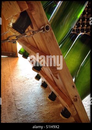 The process of riddling homemade sparkling wine using a traditional ...