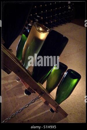 The process of riddling homemade sparkling wine using a traditional ...
