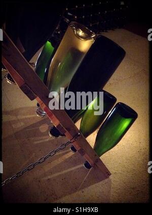 The process of riddling homemade sparkling wine using a traditional ...
