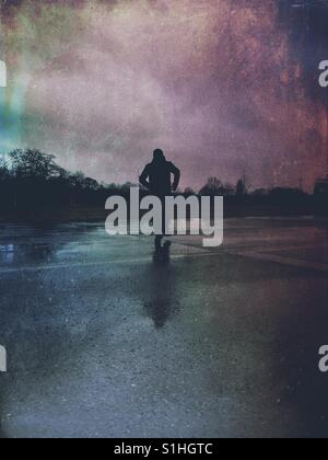 Mysterious male figure running away outdoors Stock Photo - Alamy