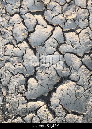 Dried mud puddle with dry cracks and traces of rain drops, Highway 24 ...