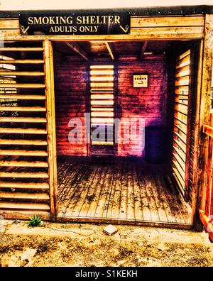 Smoking Shelter sign at designated outdoor smoking area where cigarette ...