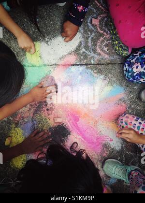 Children coloring pavement with chalk Stock Photo - Alamy