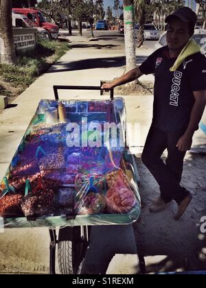 Street Candy Vendor. A young man walks the main street of Tulum ...