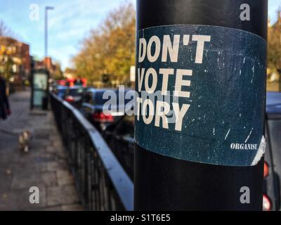 A 'Don't vote Tory' sticker on a lamppost in Archway in London, England ...