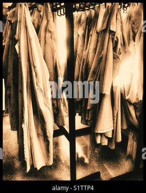 Rows of lab coats hanging up in sunlight Stock Photo - Alamy