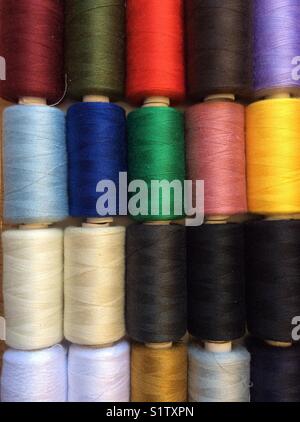 collection of spool of colorful color sewing thread used in fabric and ...