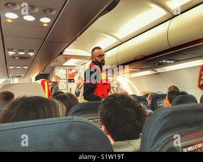 Emergency services. Paramedics boarding an EasyJet flight after a ...
