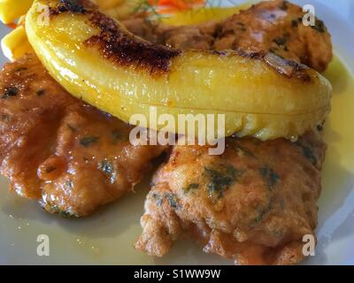 Scabbard fish with French fries, topped with a fried banana. A typical ...