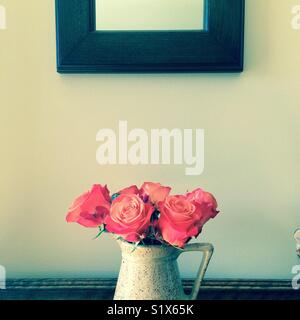 Red, orange and pink roses in a botanical park on display Stock Photo ...