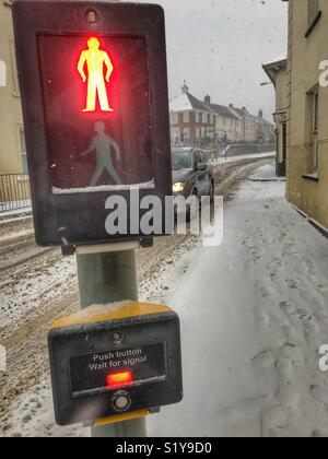 Pedestrian crossing, red light, with heavy snowfall in Sherborne ...