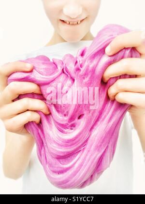 Child hands playing with slime goo. Little girl close-up hand and ...