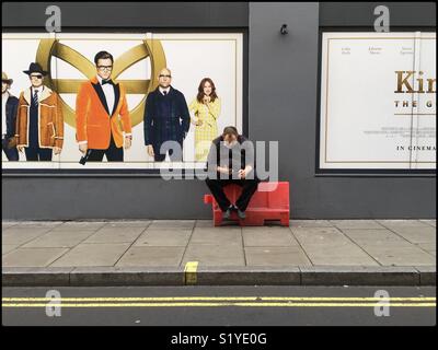 man sitting hunched over looking down drunk outside beach side bar in ...