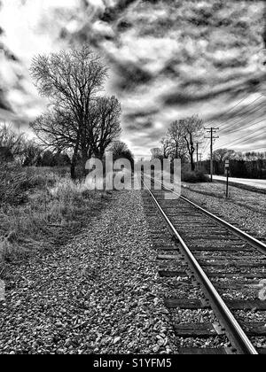 View of railroad tracks with dramatic sky Stock Photo - Alamy