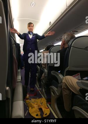 Cabin crew giving the safety demonstration on board a Ryanair flight ...