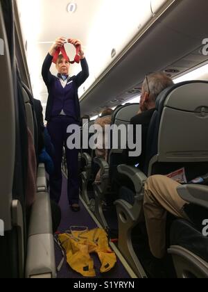 Cabin crew giving the safety demonstration on board a Ryanair flight ...
