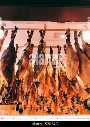 Serrano hams hanging from the ceiling in tapas bar in Sevilla Andalucia ...