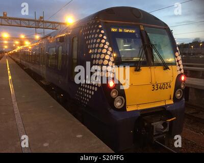 ScotRail class 334 Juniper passenger train waiting in a railway station ...
