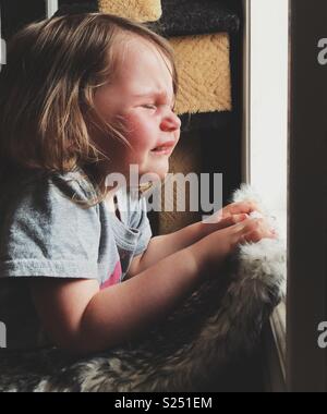 Toddler girl crying at a window during a temper tantrum Stock Photo - Alamy