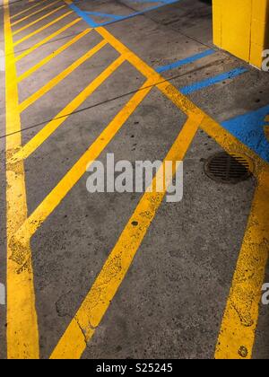 Diagonal yellow stripes of crosswalk on black background, close-up ...