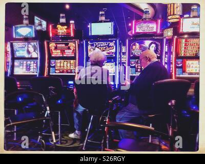 A couple playing the slot machines in the Casino of the Wynn Hotel ...