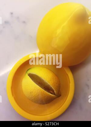 Lemon on cutting board with plastic knife Stock Photo - Alamy