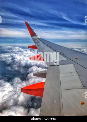 A view out of an easyJet aircraft window. The plane is cruising above ...