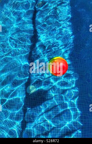 red ball floating in a pool Stock Photo - Alamy