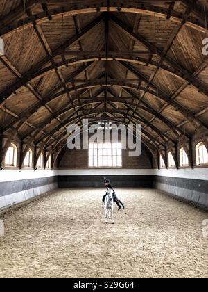 Riding lesson riding hall Stock Photo - Alamy