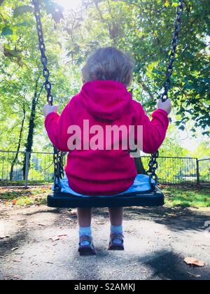 children girl swinging in a tree trunk in a pine forest Stock Photo - Alamy