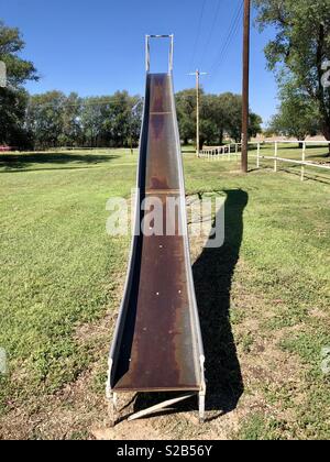 Rusty metal slide Stock Photo - Alamy