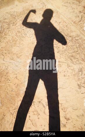 Woman flexing her muscles Stock Photo - Alamy