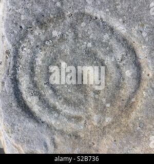 Prehistoric cup and ring mark carved stone rock art outcrop at ...