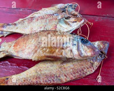 Dry fish on a red table, local food, Ukraine Stock Photo - Alamy